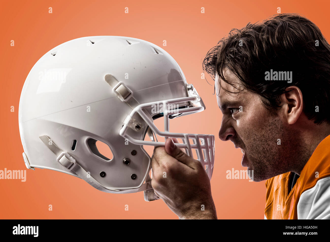 Close up of a Football Player with a orange uniform on a orange ...