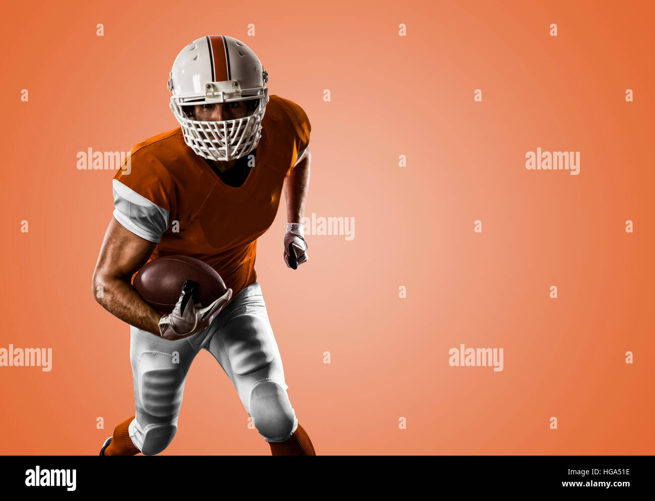 Football Player with a orange uniform Running on a orange background ...