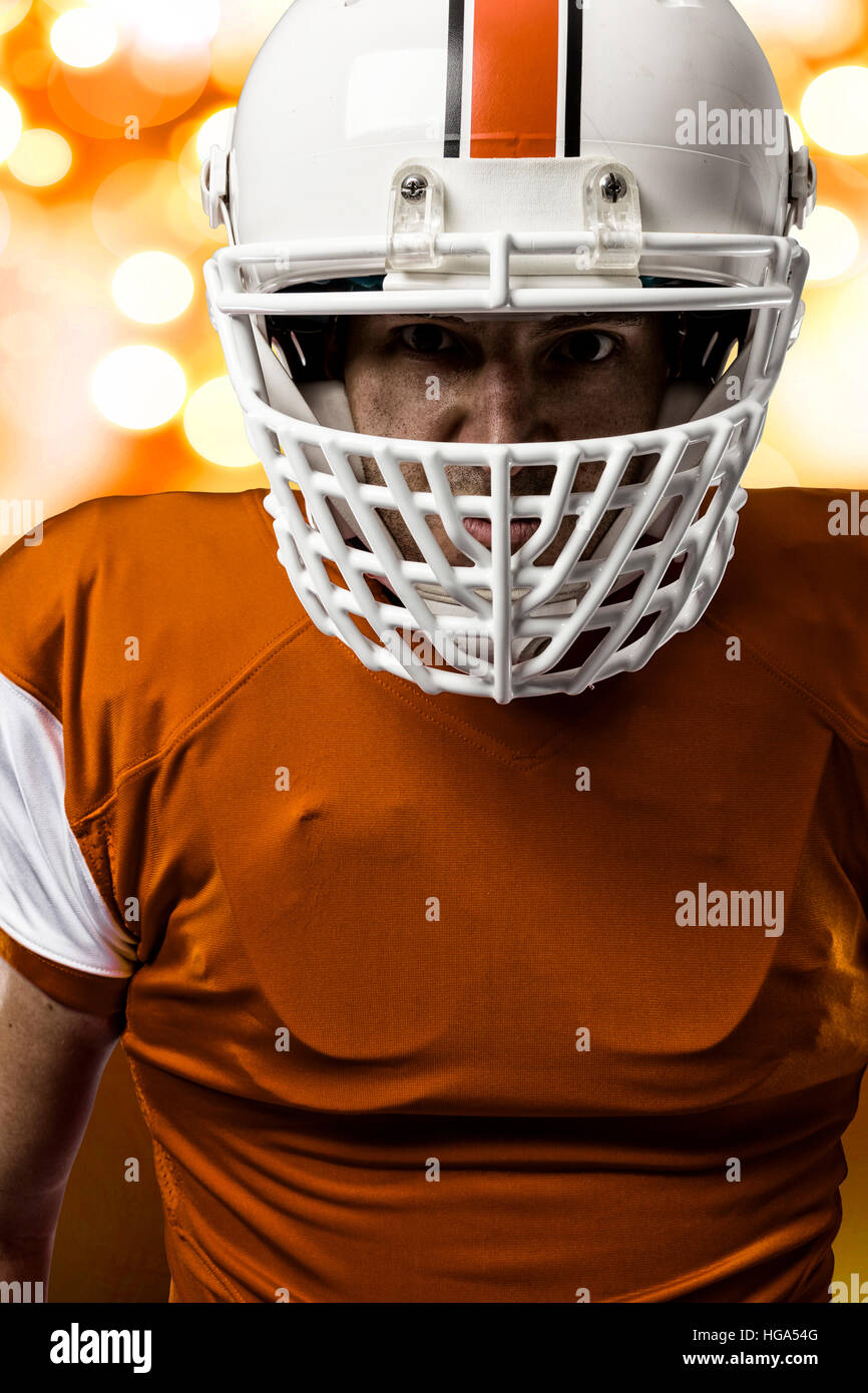 Close up of a Football Player with a orange uniform on a orange lights ...