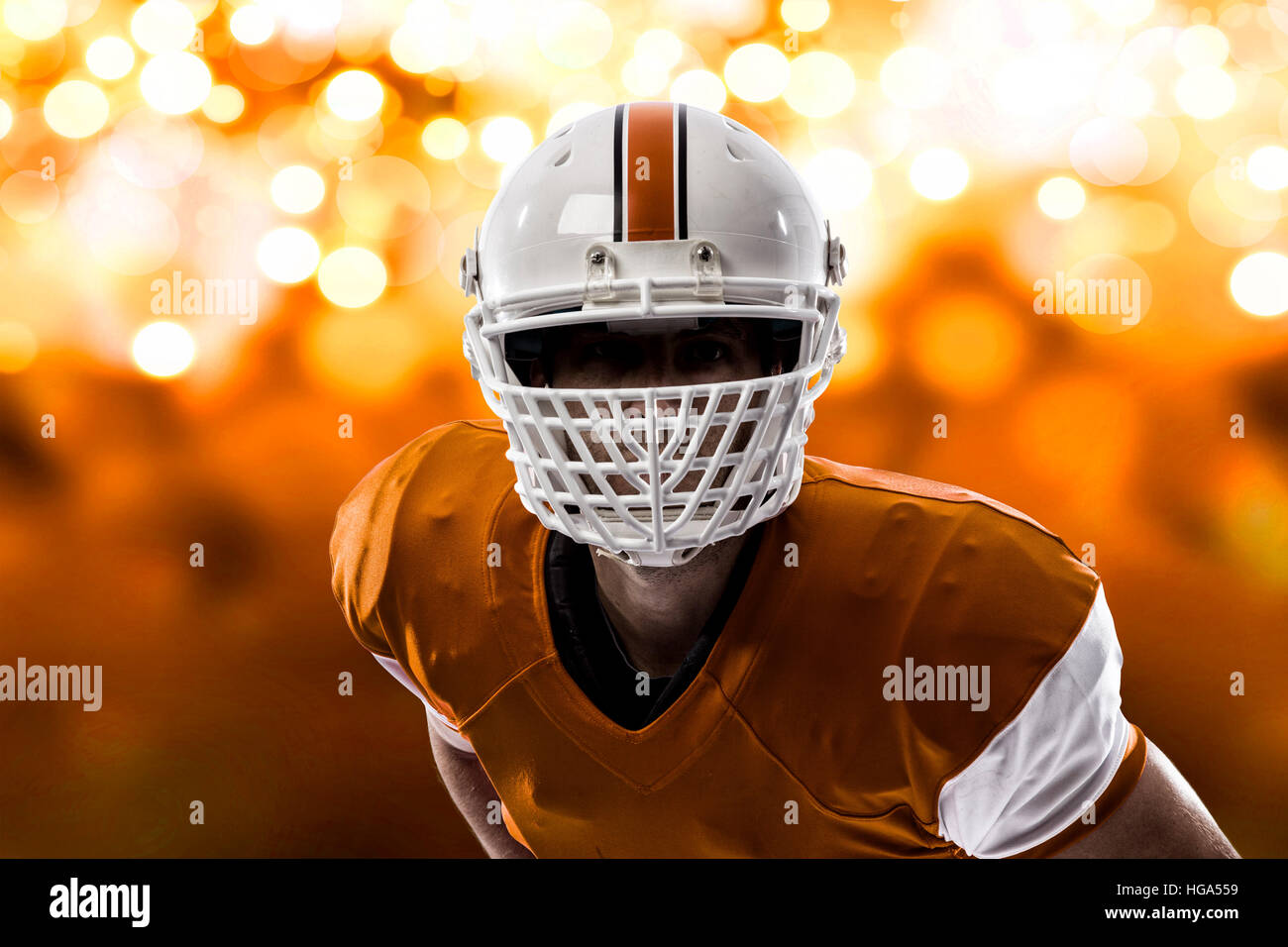Close up of a Football Player with a orange uniform on a orange lights ...
