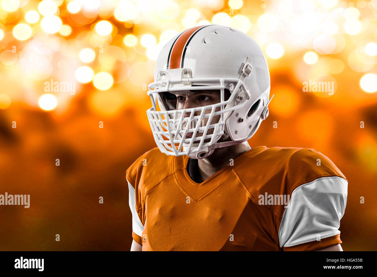 Close up of a Football Player with a orange uniform on a orange lights ...