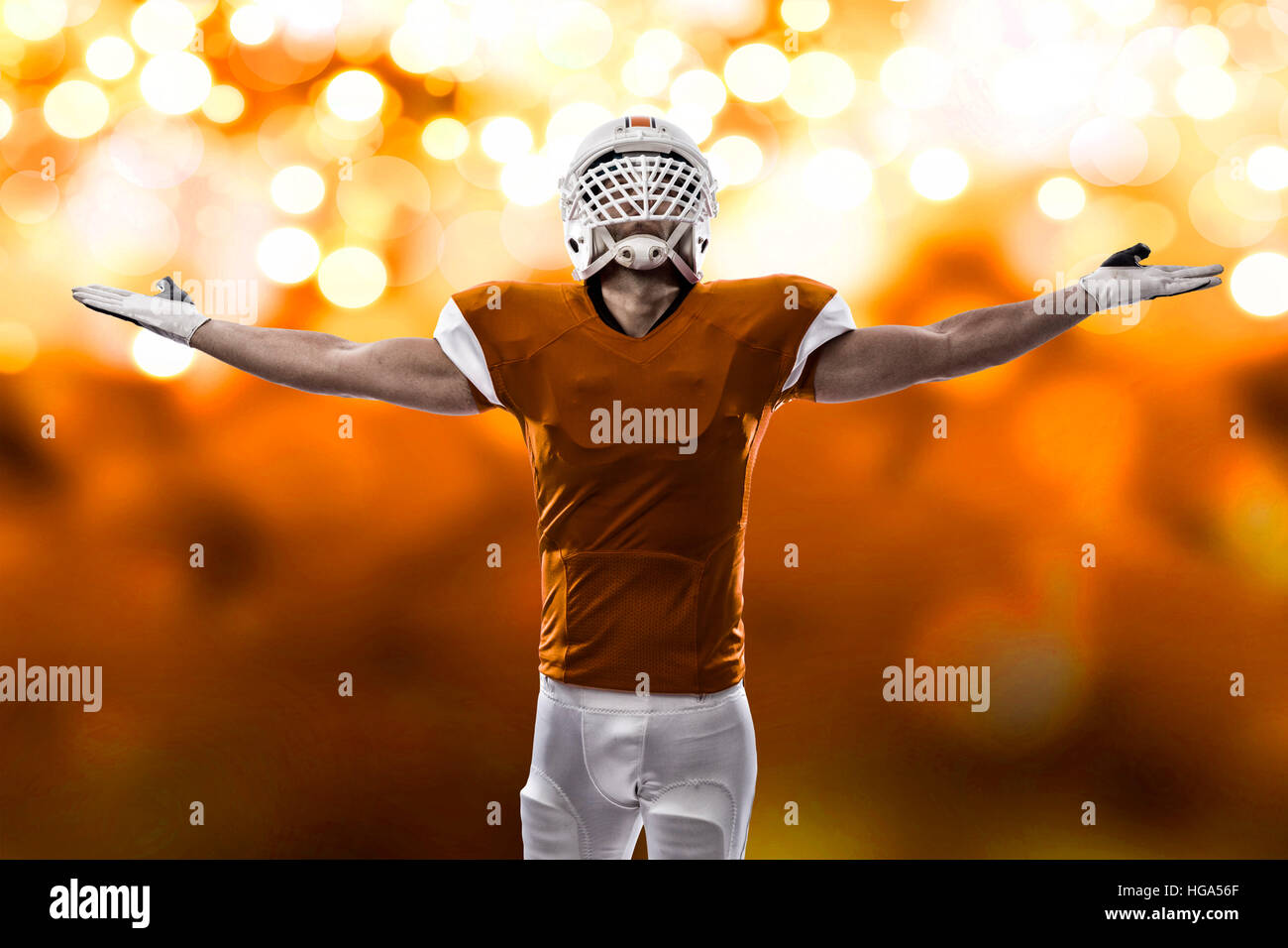 Football Player with a orange uniform celebrating, on a orange lights ...