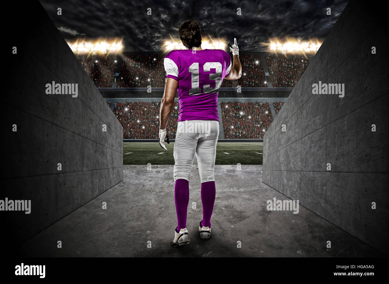 Football Player with a pink uniform walking out of a Stadium tunnel ...
