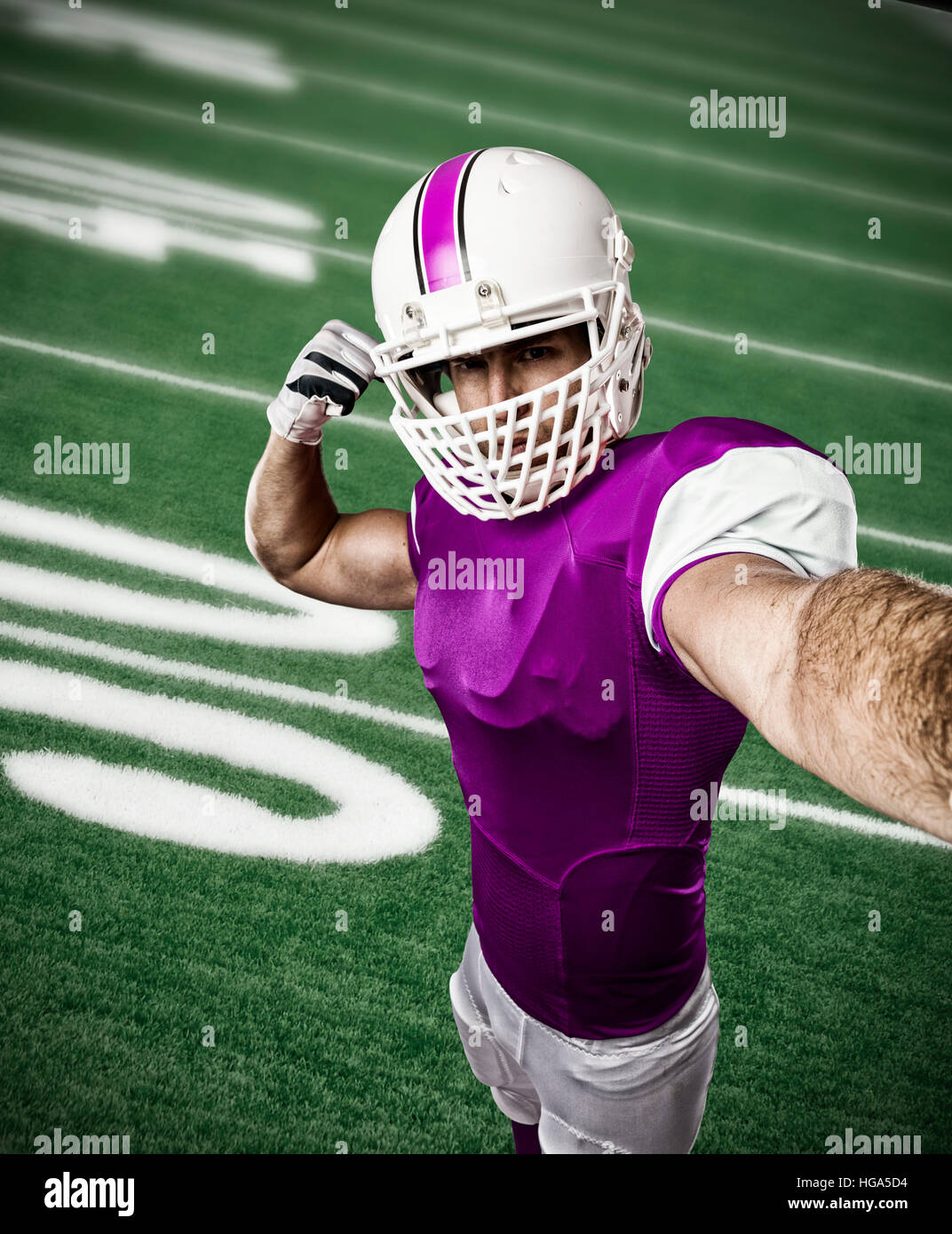 Football Player with a pink uniform making a selfie on a football field ...