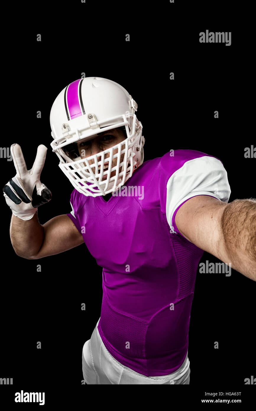 Football Player with a pink uniform making a selfie on a black ...