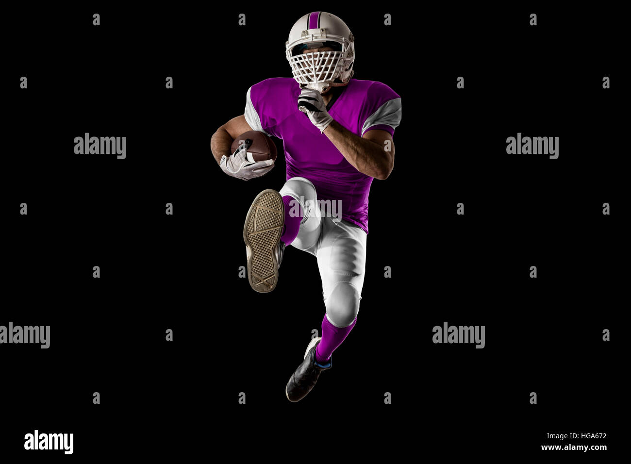 Football Player with a pink uniform Running on a black background Stock ...