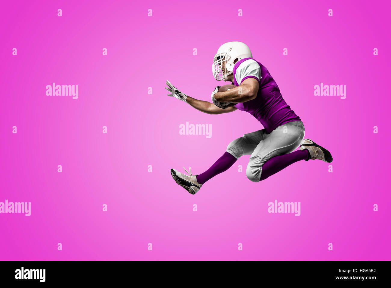 Football Player with a pink uniform Running on a pink background Stock ...