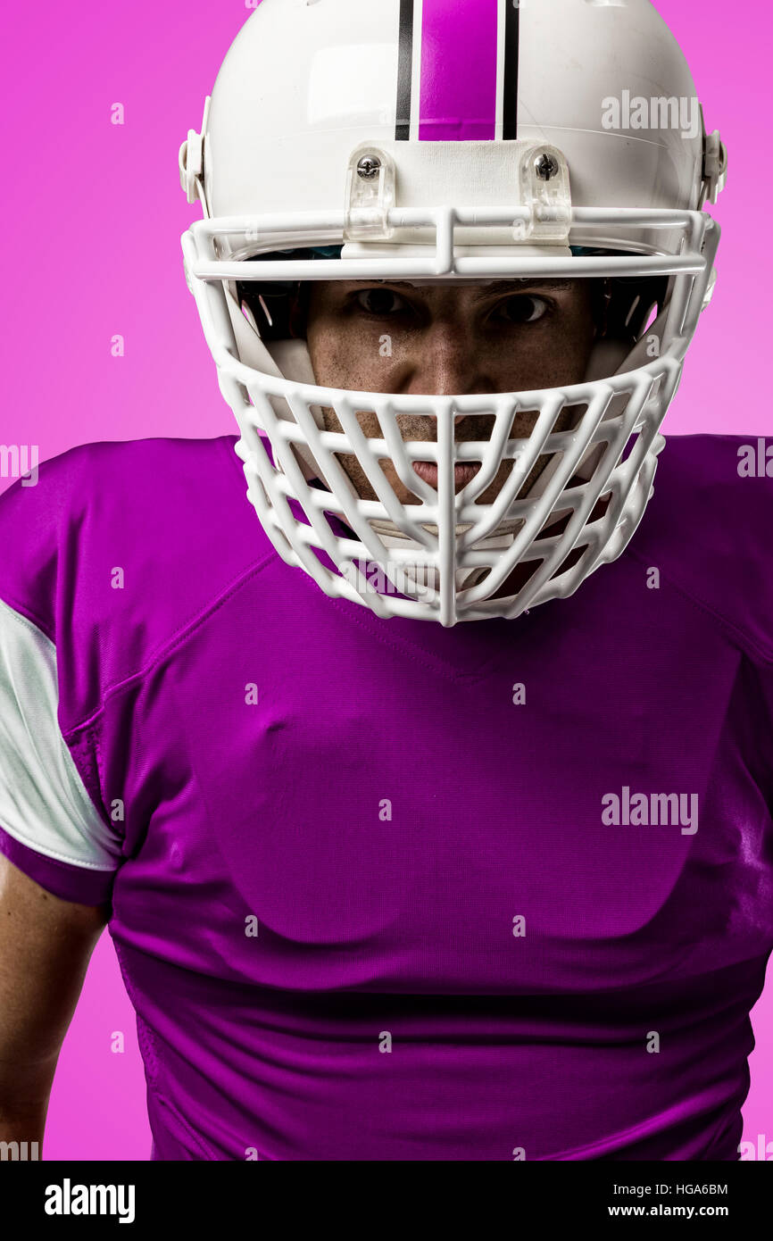 Close up of a Football Player with a pink uniform on a pink background ...