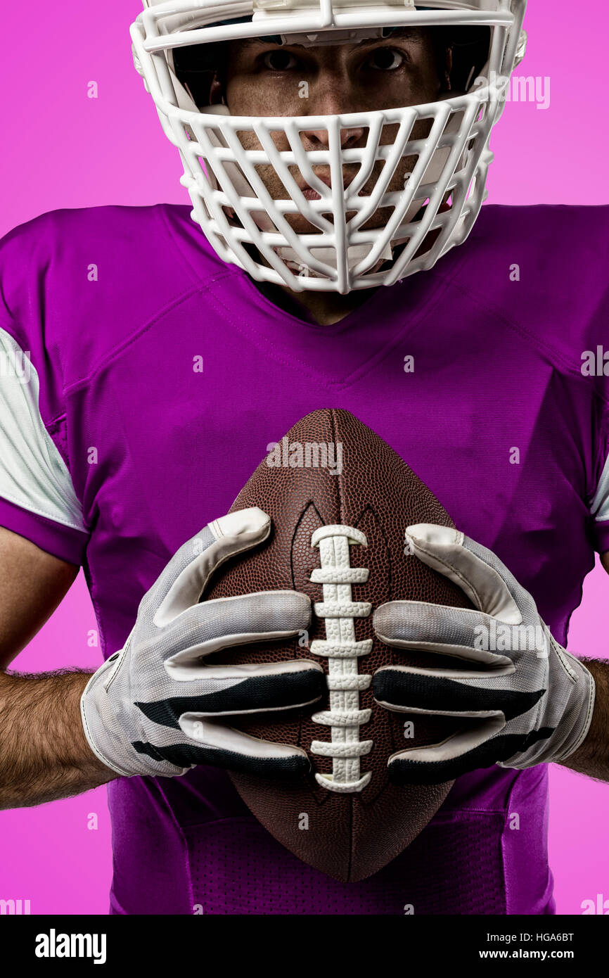 Close up of a Football Player with a pink uniform on a pink background ...