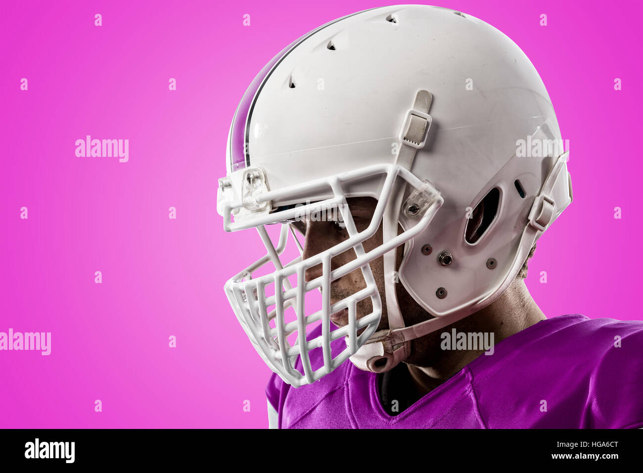 Close up of a Football Player with a pink uniform on a pink background ...