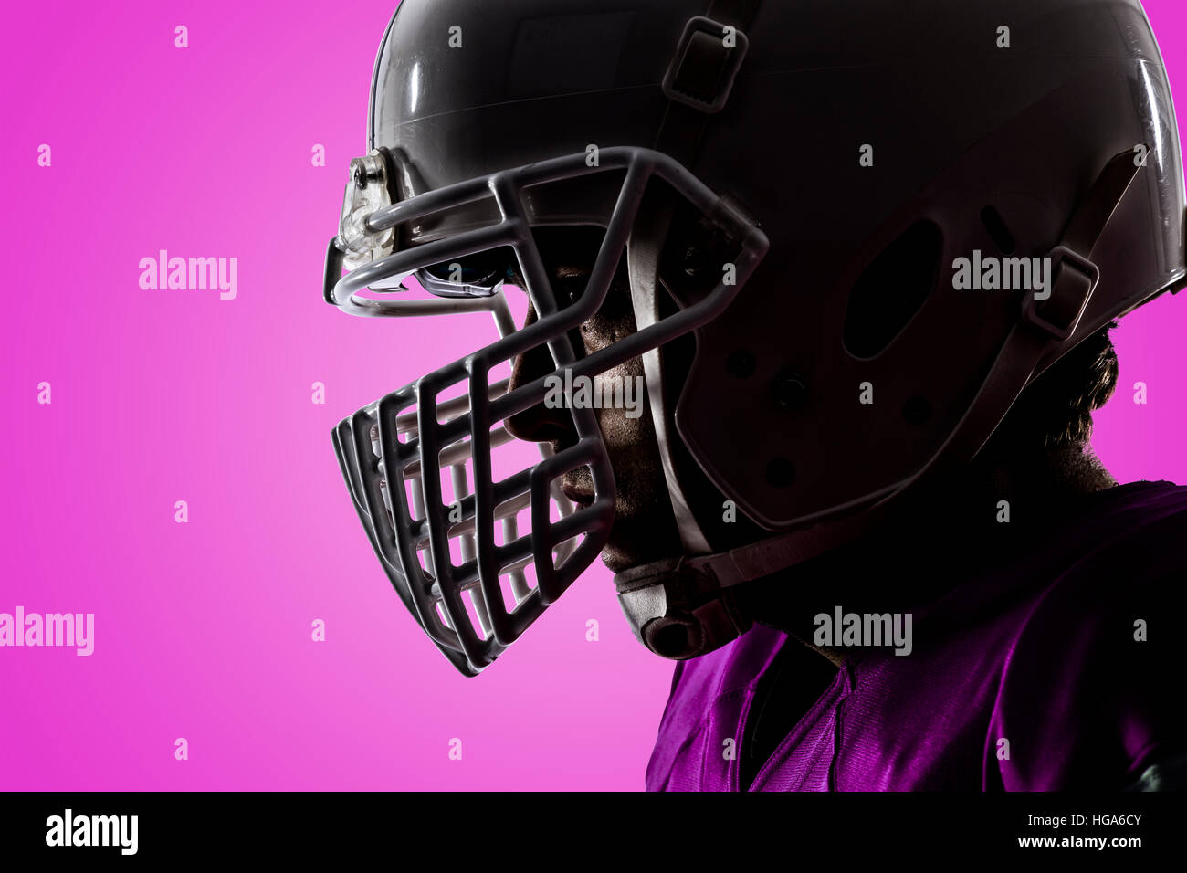 Close up of a Football Player with a pink uniform on a pink background ...