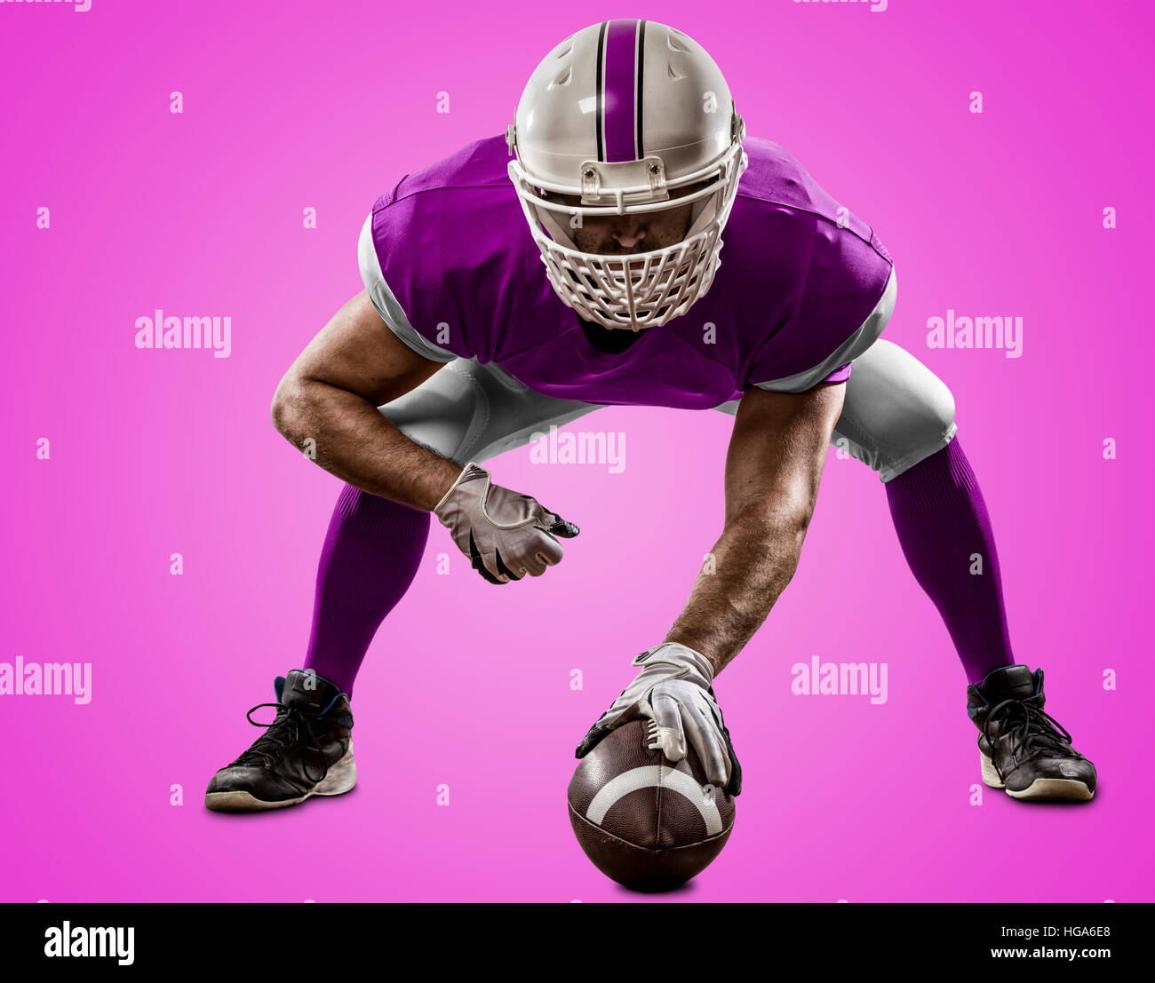 Football Player with a pink uniform on the scrimmage line, on a pink ...