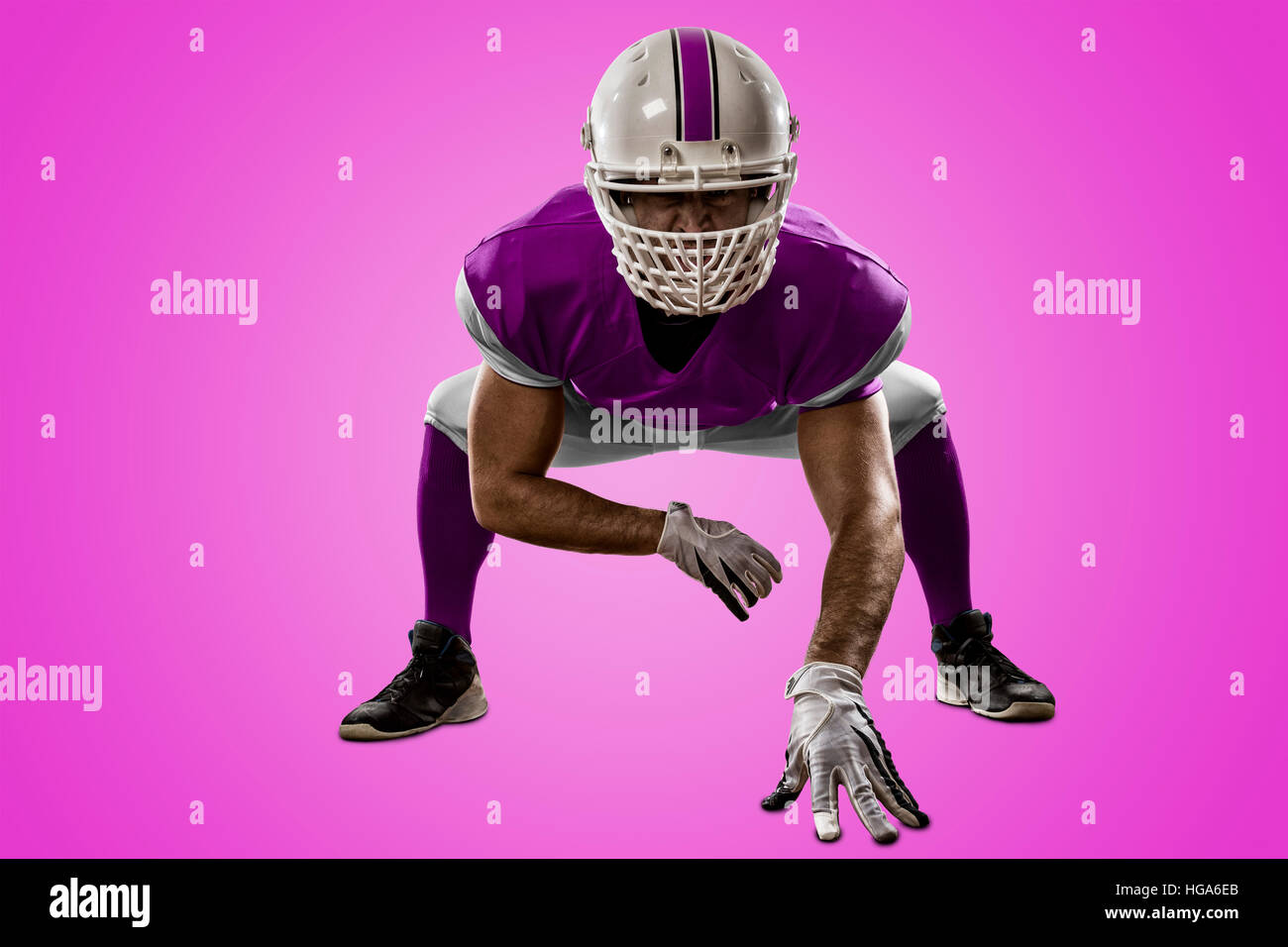 Football Player with a pink uniform on the scrimmage line, on a pink ...