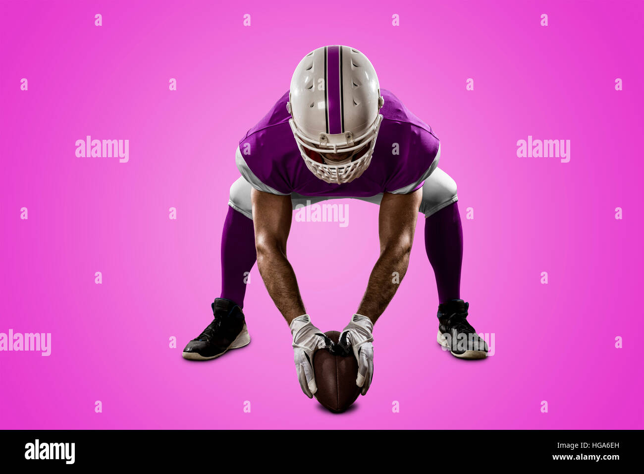 Football Player with a pink uniform on the scrimmage line, on a pink ...