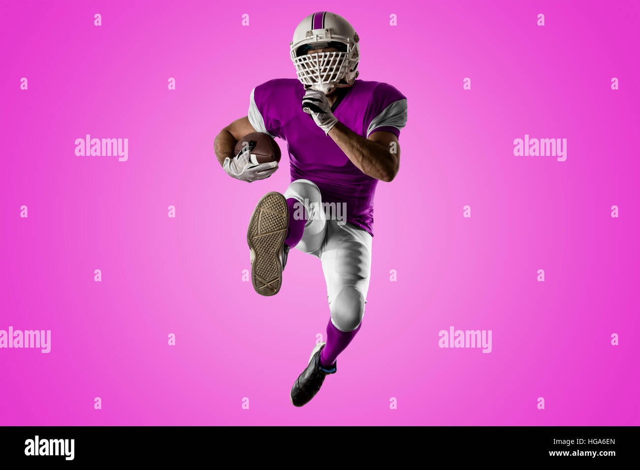 Football Player with a pink uniform Running on a pink background Stock ...