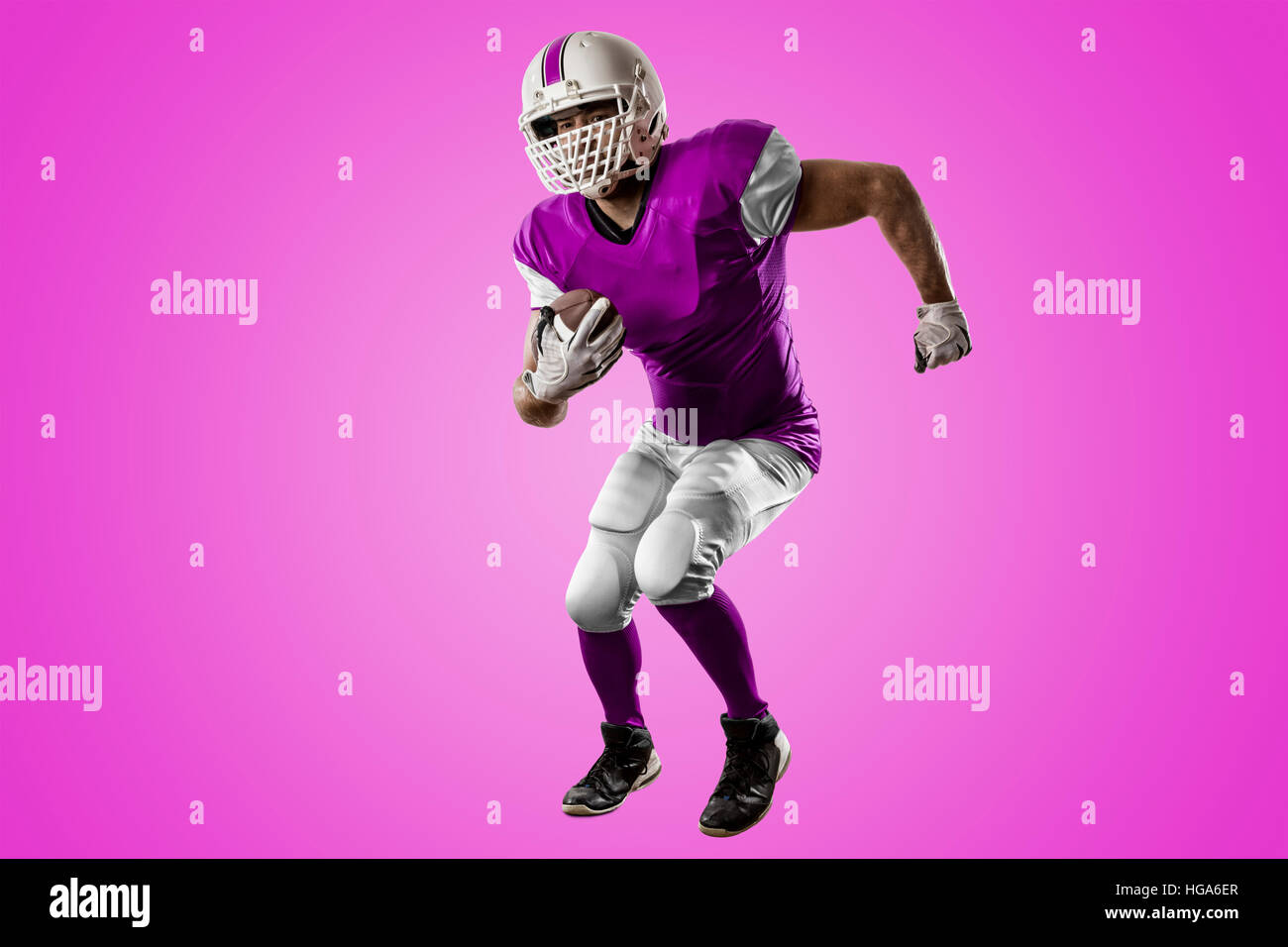 Football Player with a pink uniform Running on a pink background Stock ...