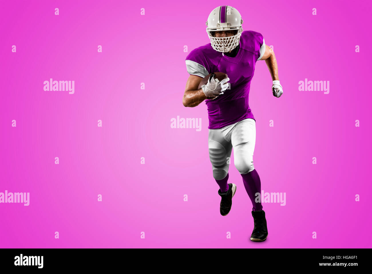 Football Player with a pink uniform Running on a pink background Stock ...