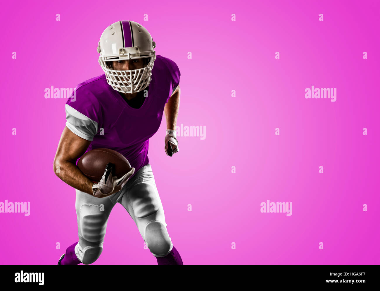 Football Player with a pink uniform Running on a pink background Stock ...