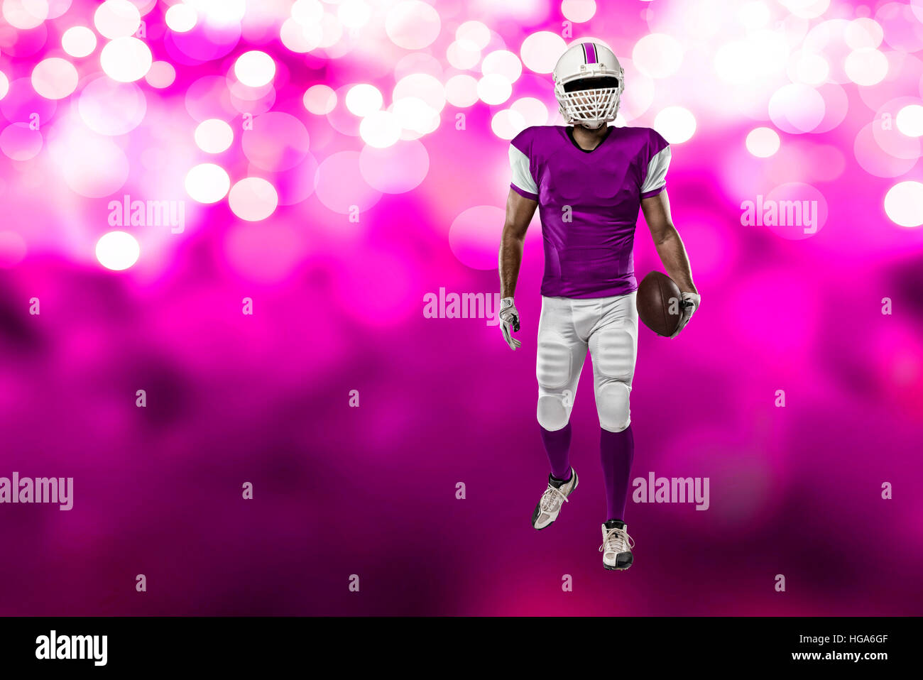 Football Player with a pink uniform on a pink lights background Stock ...