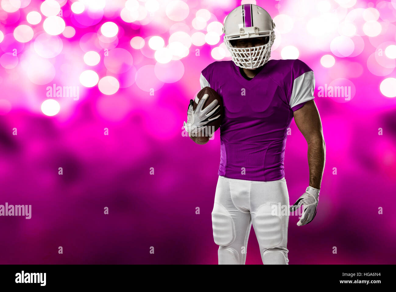 Football Player with a pink uniform on a pink lights background Stock ...