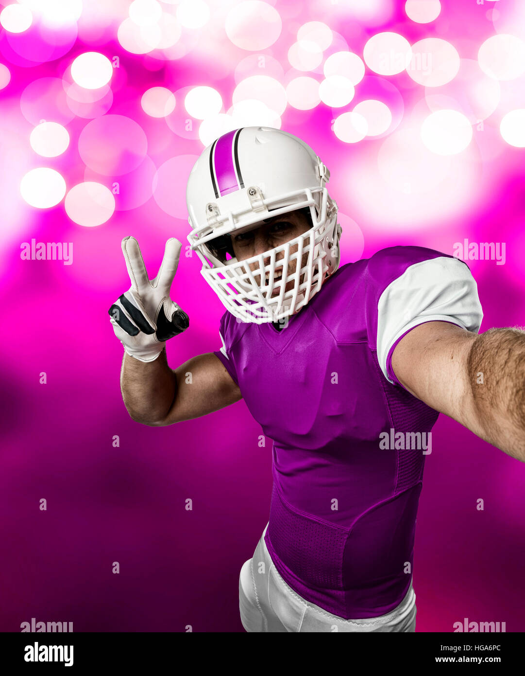 Football Player with a pink uniform making a selfie on a pink lights ...