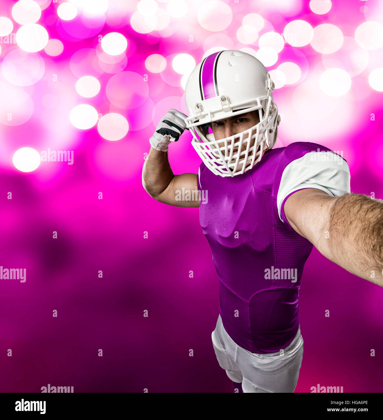 Football Player with a pink uniform making a selfie on a pink lights ...