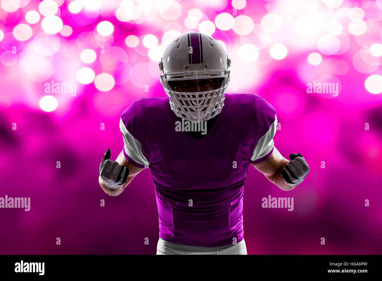 Football Player with a pink uniform on a pink lights background Stock ...