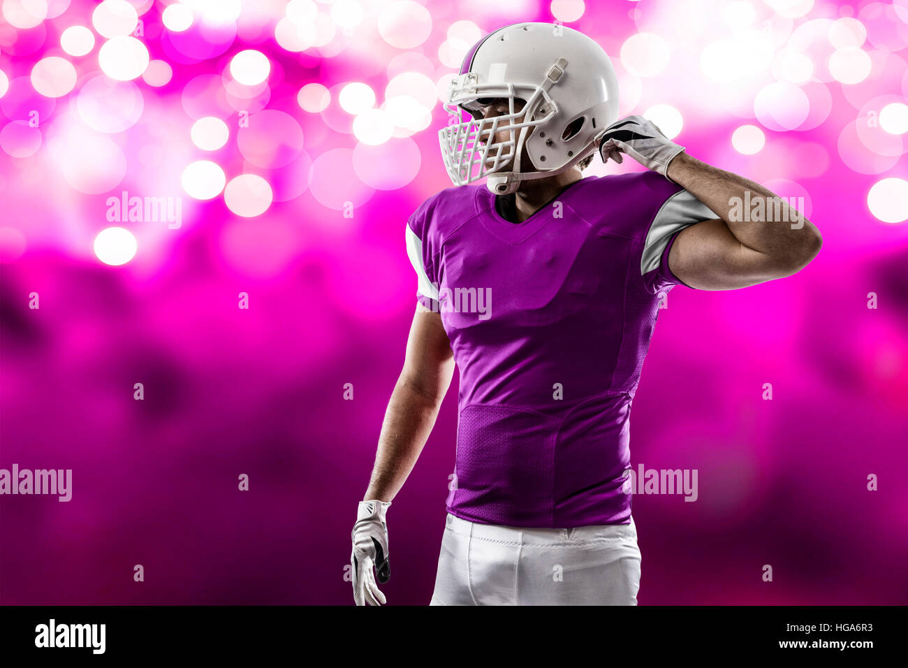 Football Player with a pink uniform on a pink lights background Stock ...