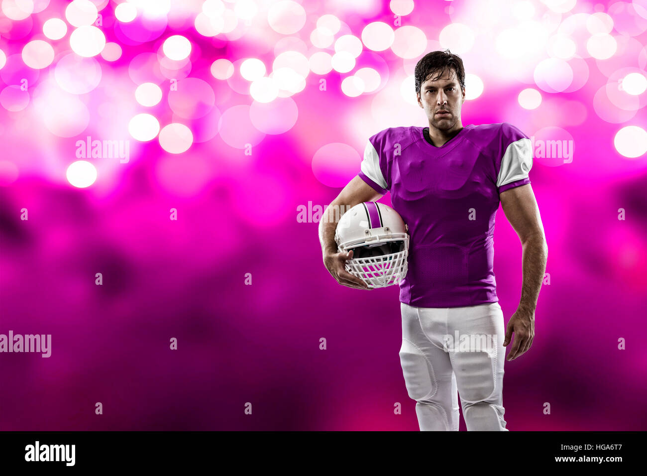 Football Player with a pink uniform on a pink lights background Stock ...