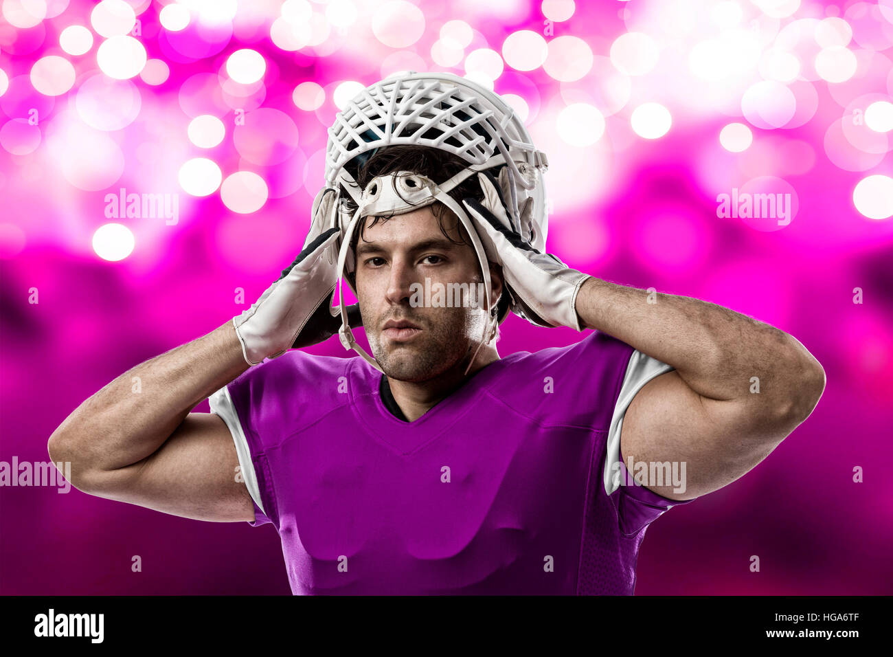 Football Player with a pink uniform on a pink lights background Stock ...