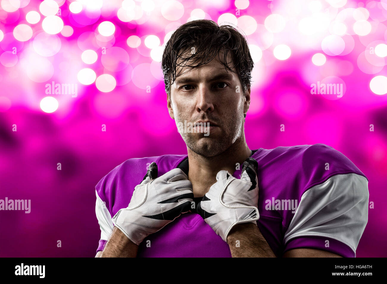 Football Player with a pink uniform on a pink lights background Stock ...