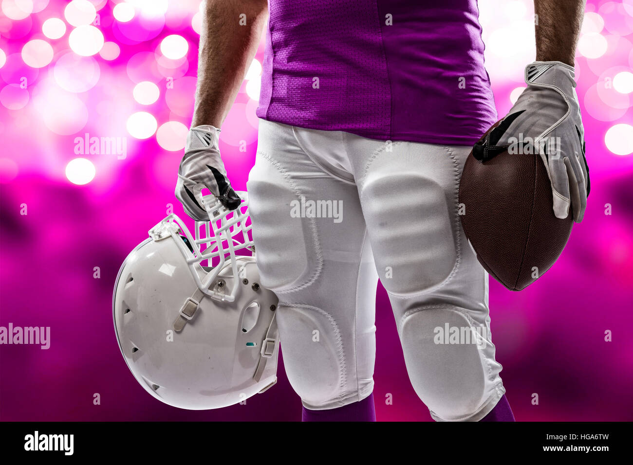 Football Player with a pink uniform on a pink lights background Stock ...