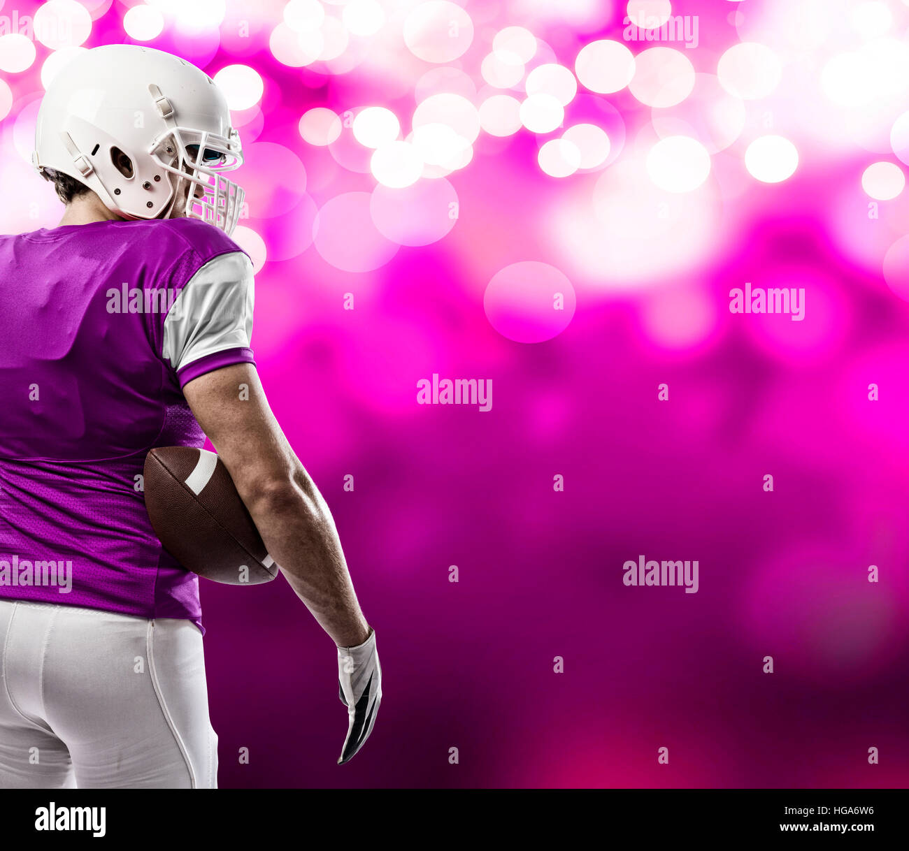 Football Player with a pink uniform on a pink lights background Stock ...