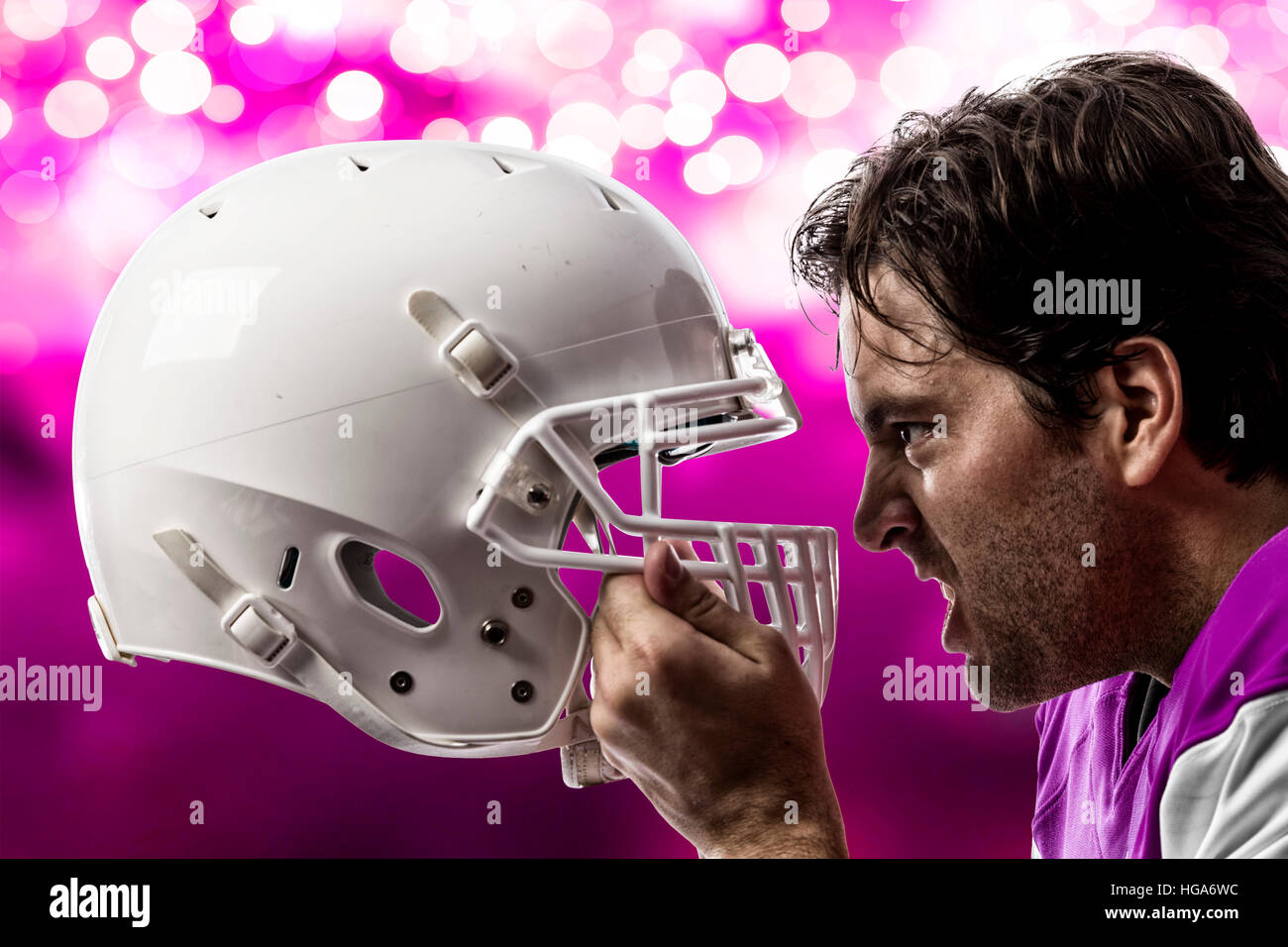 Close up of a Football Player with a pink uniform on a pink lights ...