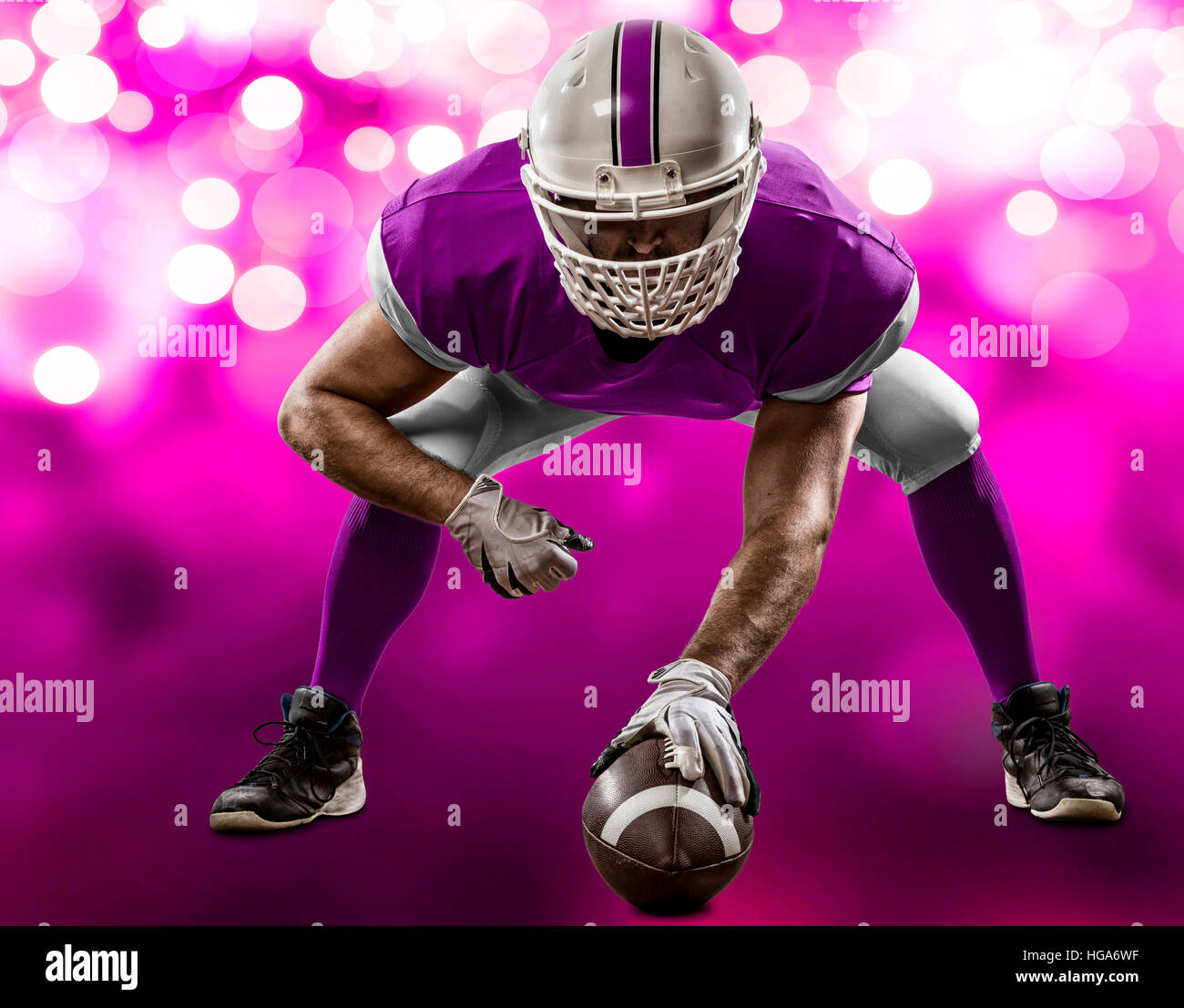Football Player with a pink uniform on the scrimmage line, on a pink ...