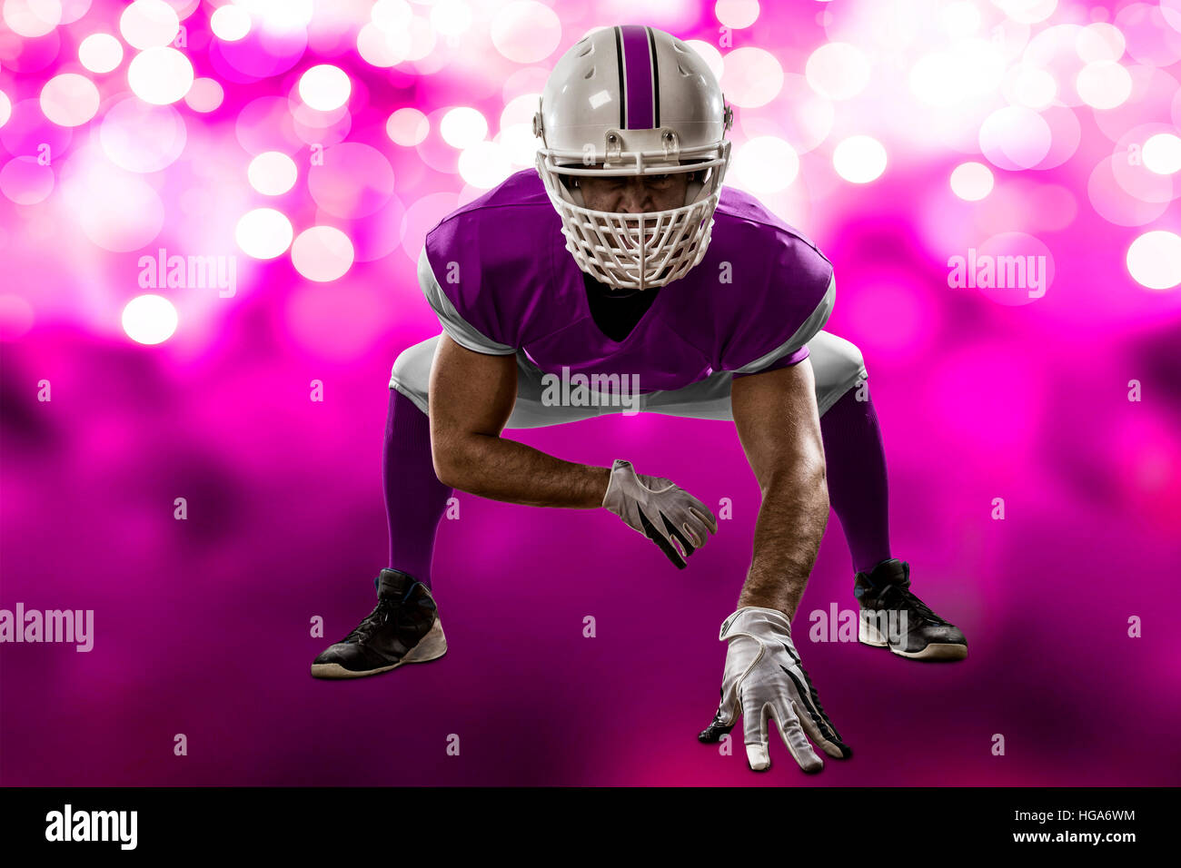 Football Player with a pink uniform on the scrimmage line, on a pink ...