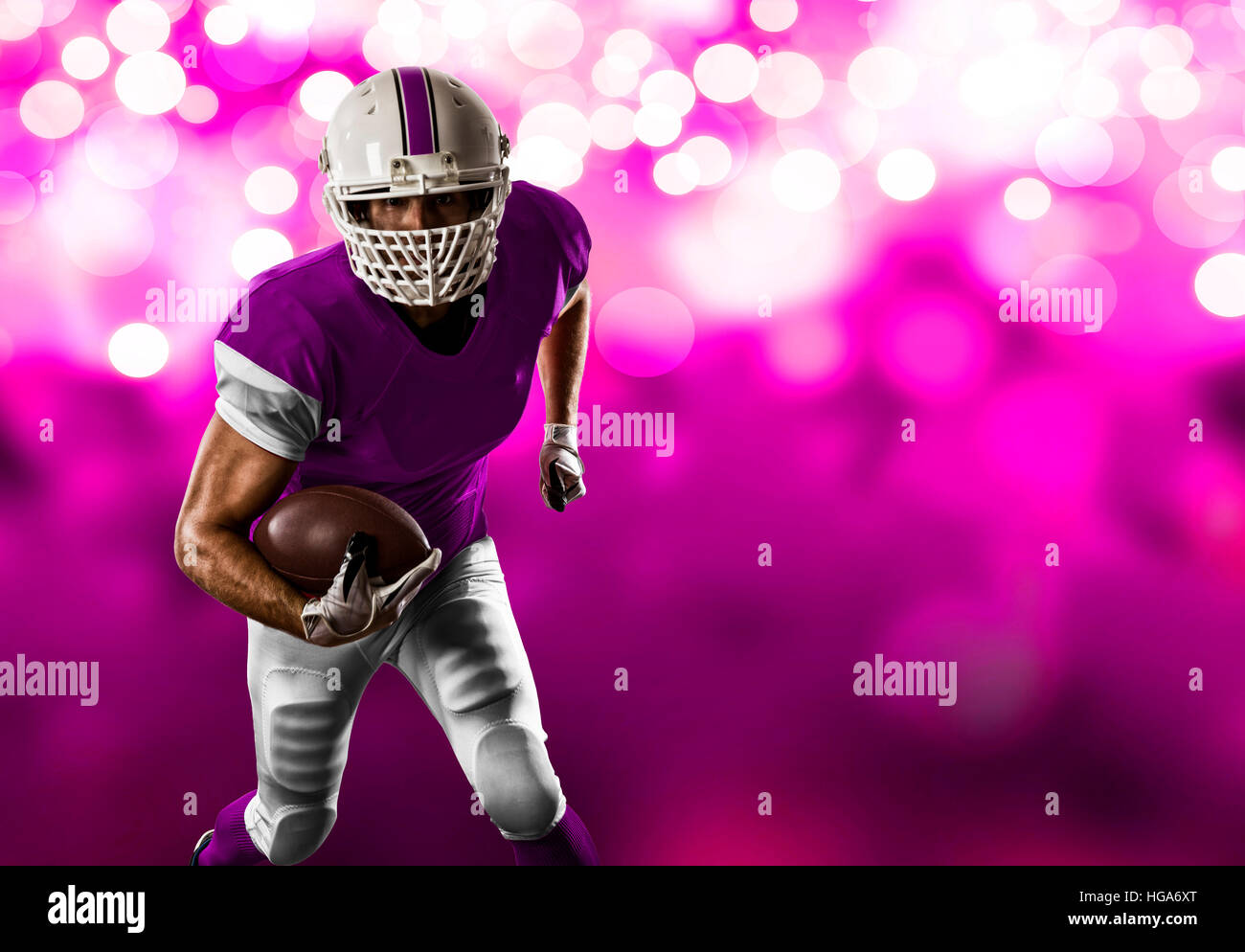 Football Player with a pink uniform Running on a pink lights background ...