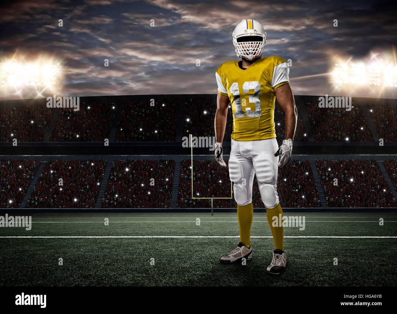 Football Player with a yellow uniform on a stadium Stock Photo - Alamy