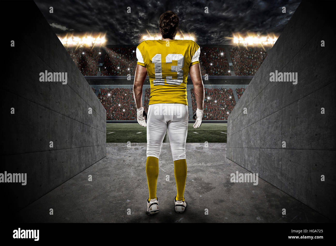 Football Player with a yellow uniform walking out of a Stadium tunnel ...