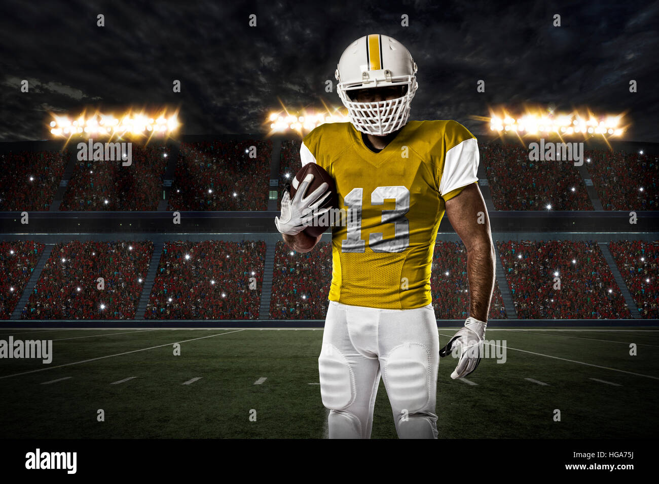 Football Player with a yellow uniform on a stadium Stock Photo - Alamy
