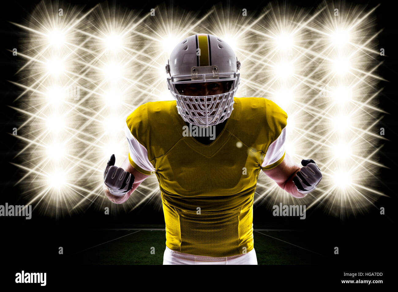 Football Player with a yellow uniform in front of lights Stock Photo ...