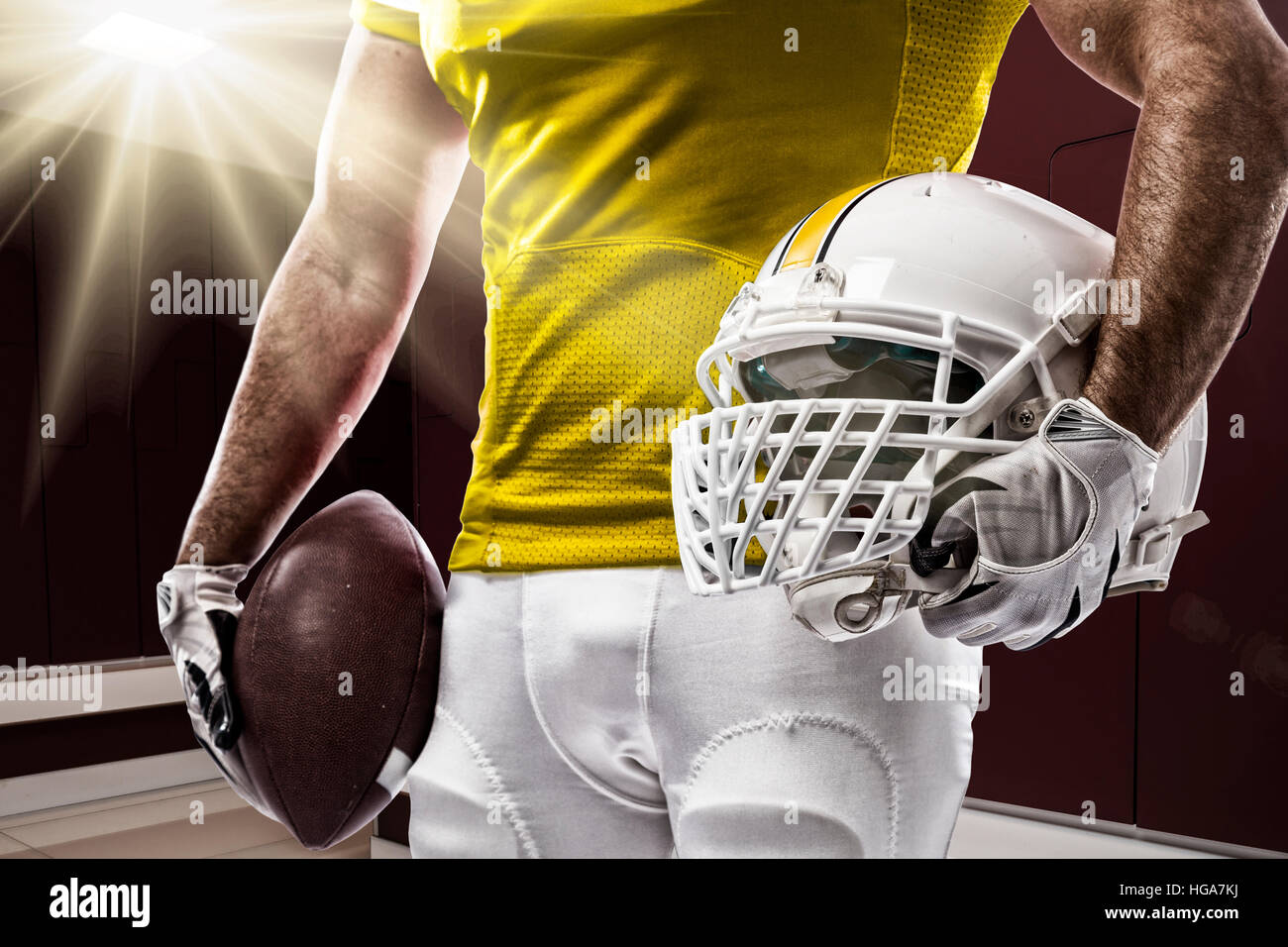 Football Player with a yellow uniform on a Locker roon Stock Photo - Alamy