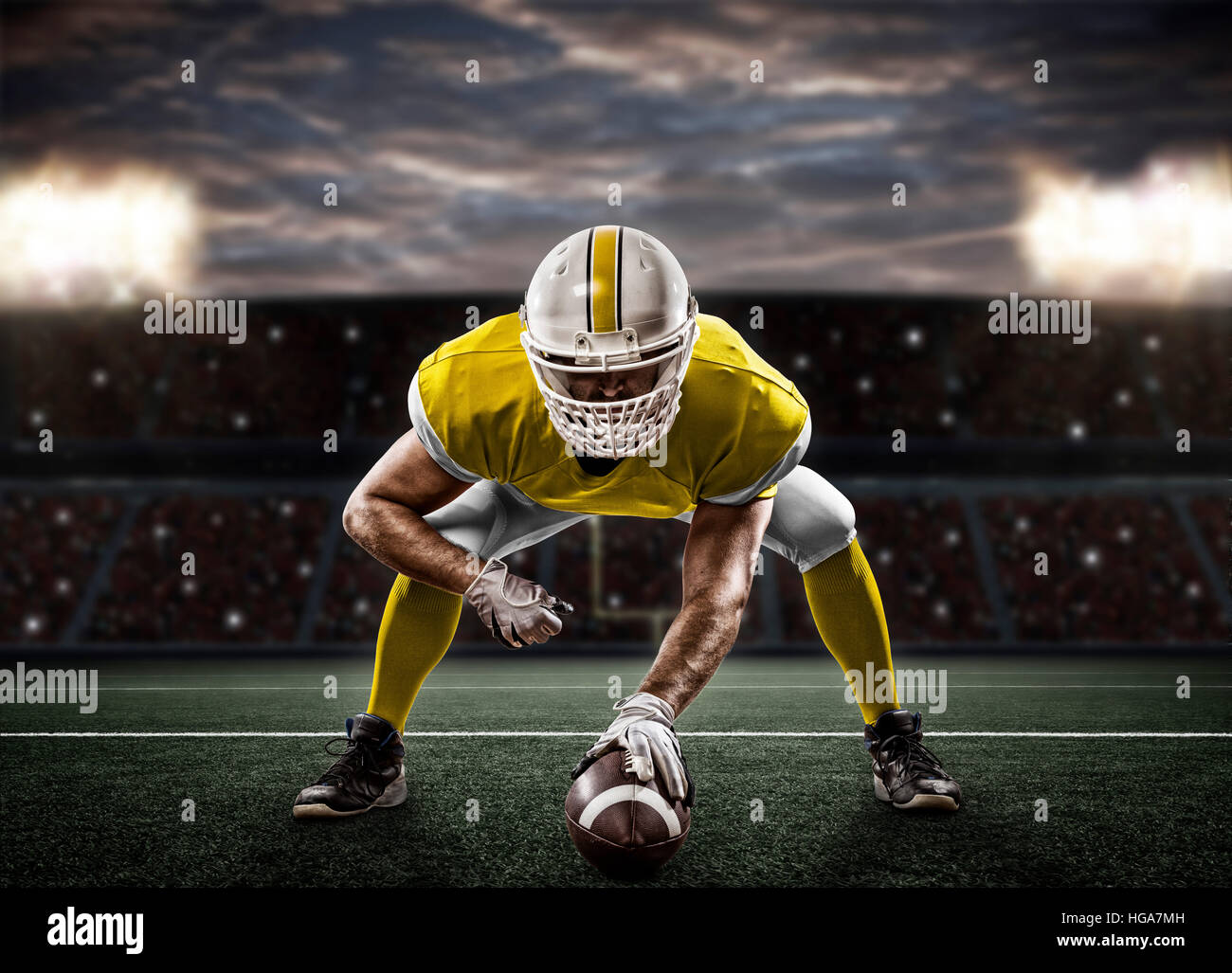 Football Player with a yellow uniform on the scrimmage line, on a ...