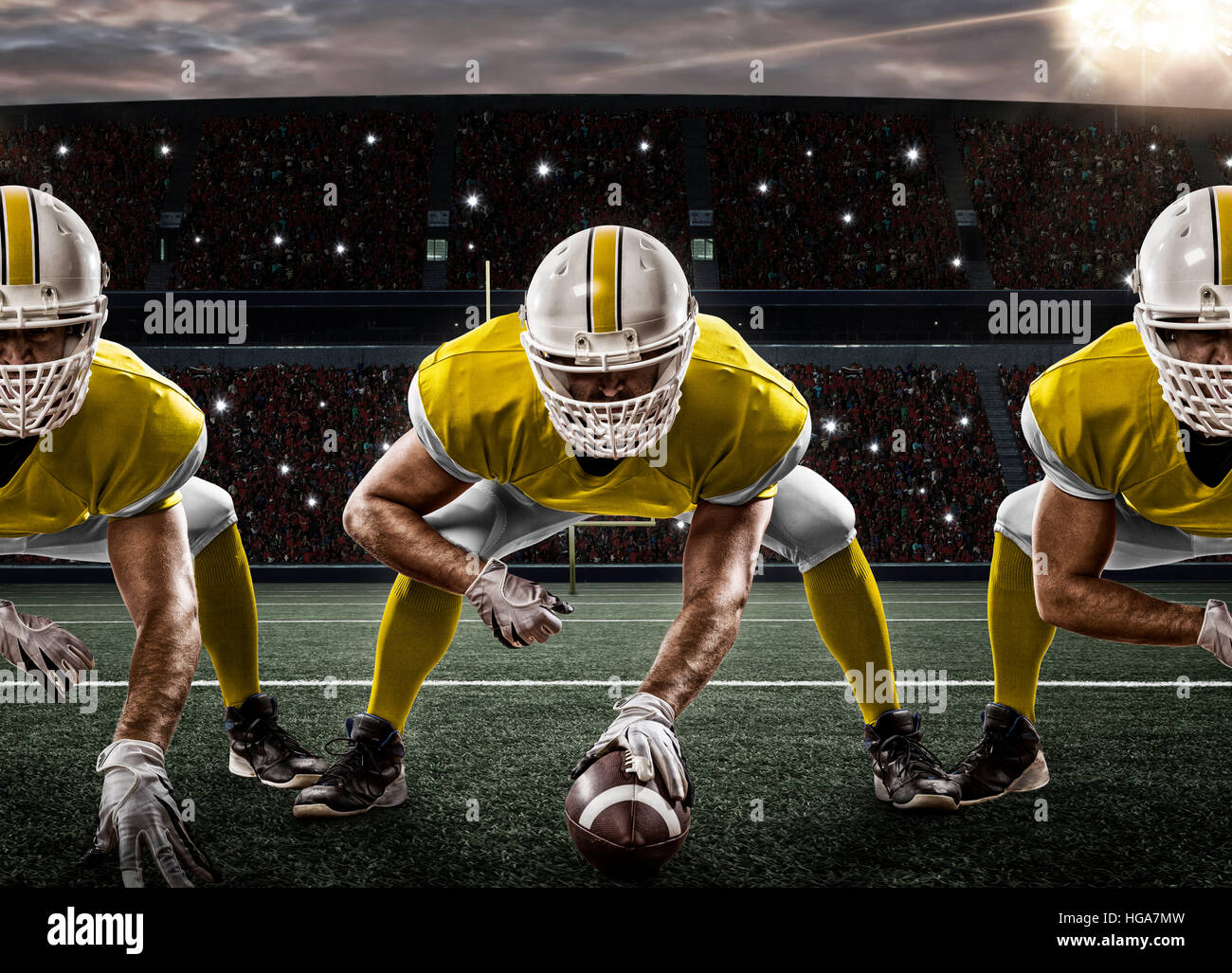 Football Players with a yellow uniform on the scrimmage line, on a ...