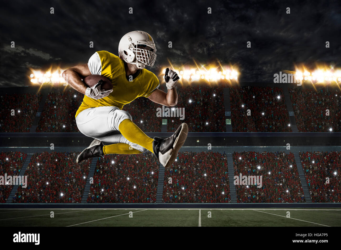 Football Player with a yellow uniform running on a stadium Stock Photo ...