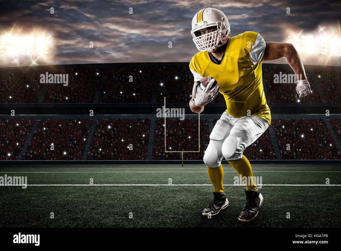 Football Player with a yellow uniform running on a stadium Stock Photo ...