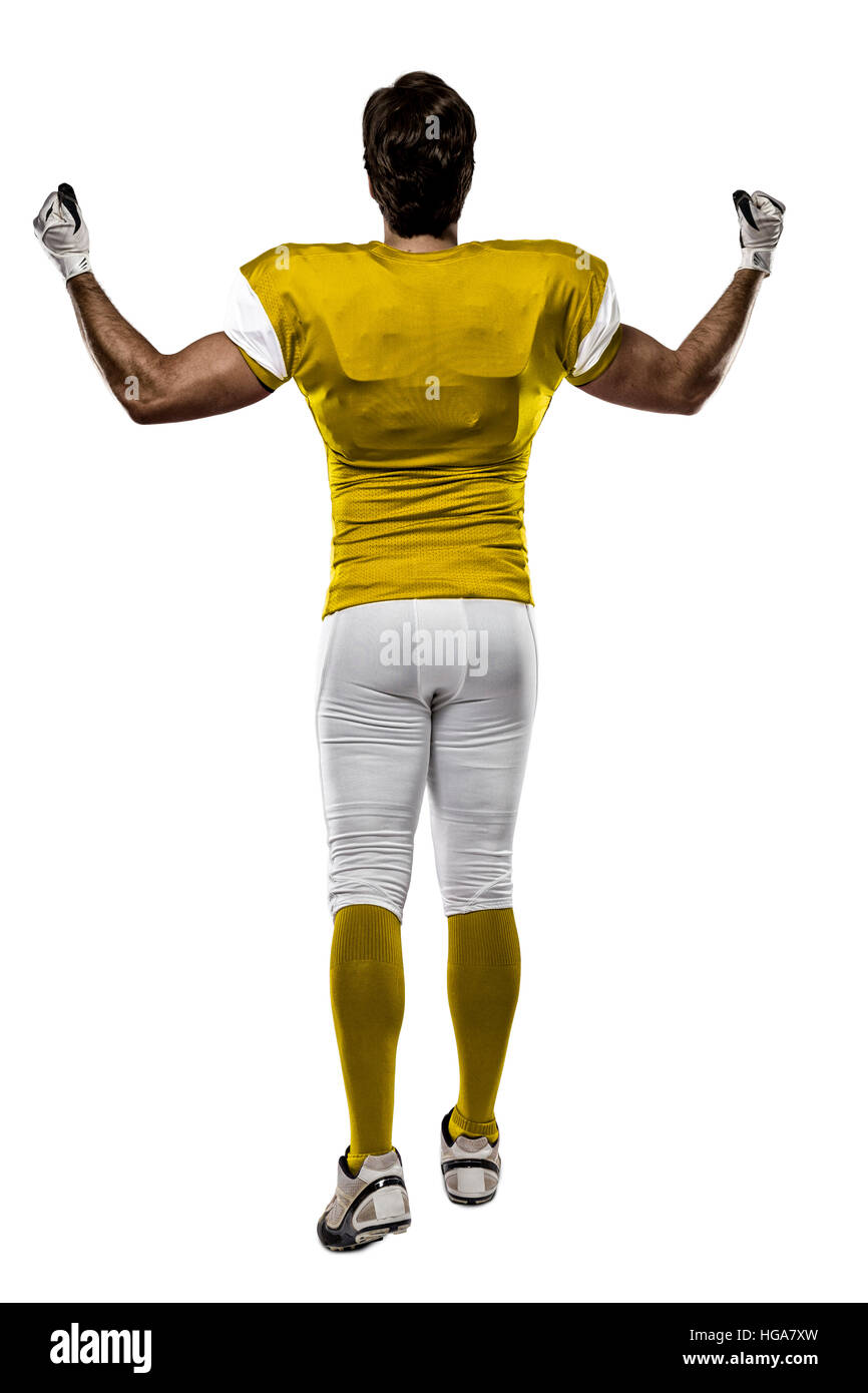Football Player with a yellow uniform walking, showing his back on a ...