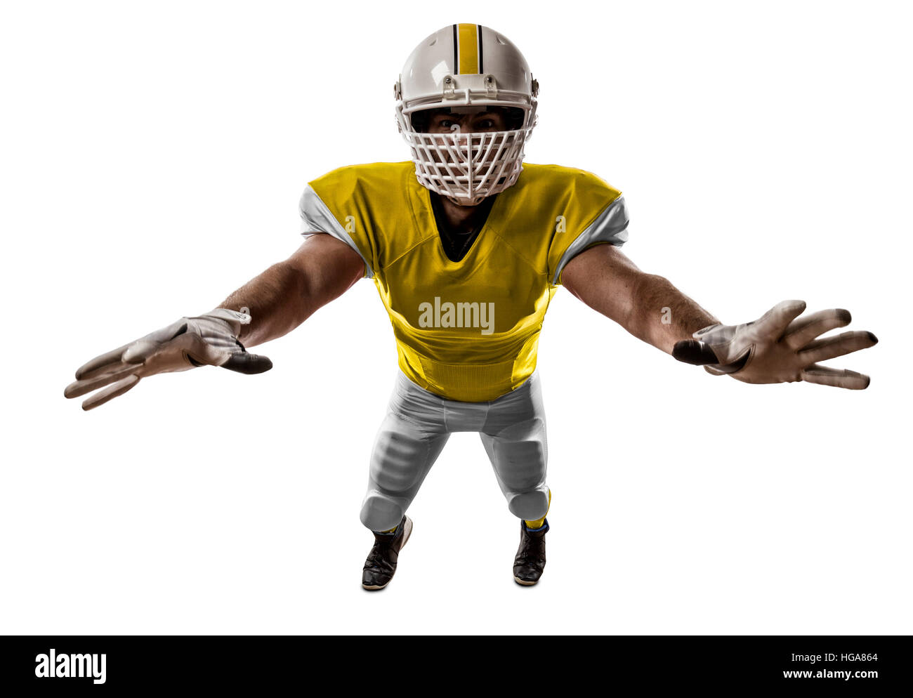 Football Player with a yellow uniform making a tackle on a white ...