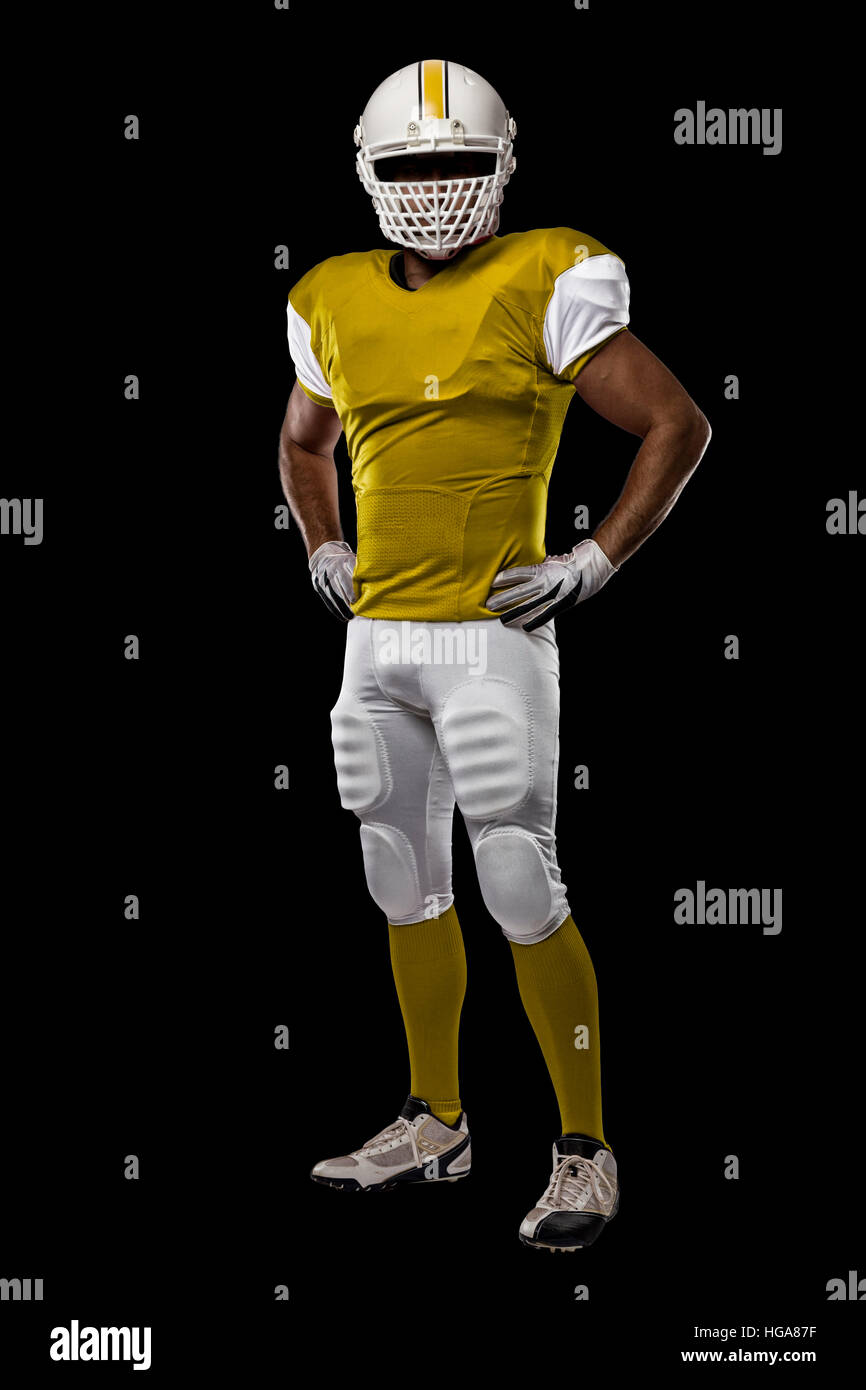 Football Player with a yellow uniform on a black background Stock Photo ...