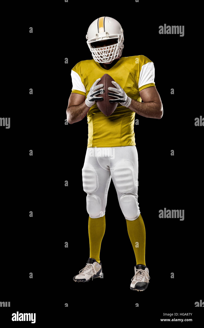 Football Player with a yellow uniform on a black background Stock Photo ...